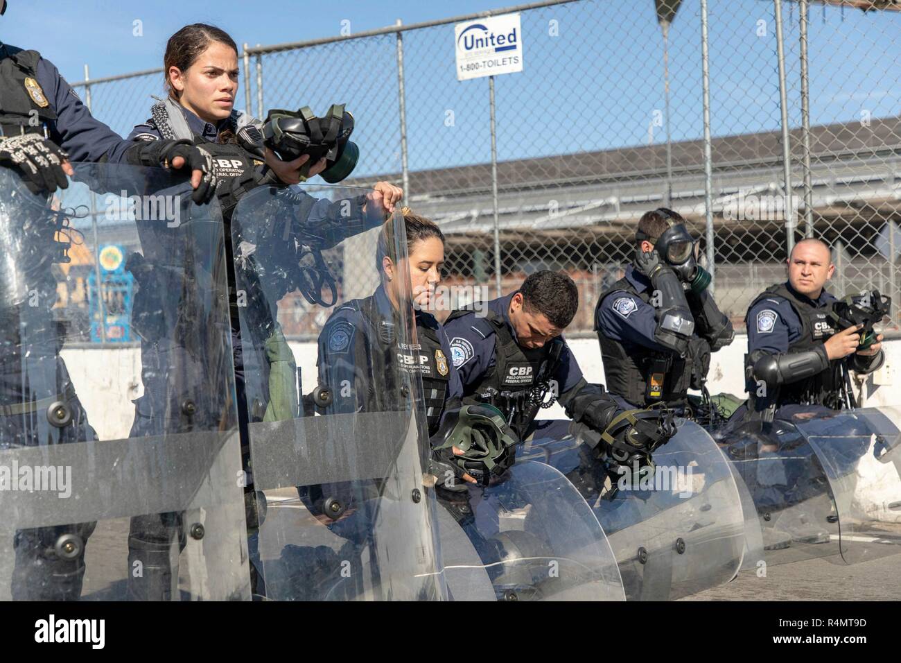 U.S. Customs and Border Patrol agents in riot gear shut the border into ...
