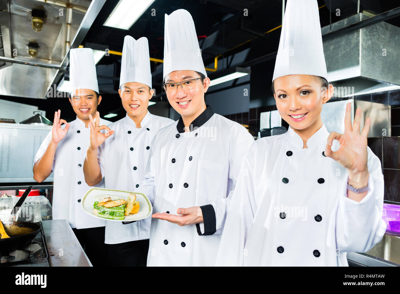 Asian Chefs in hotel restaurant kitchen Stock Photo - Alamy
