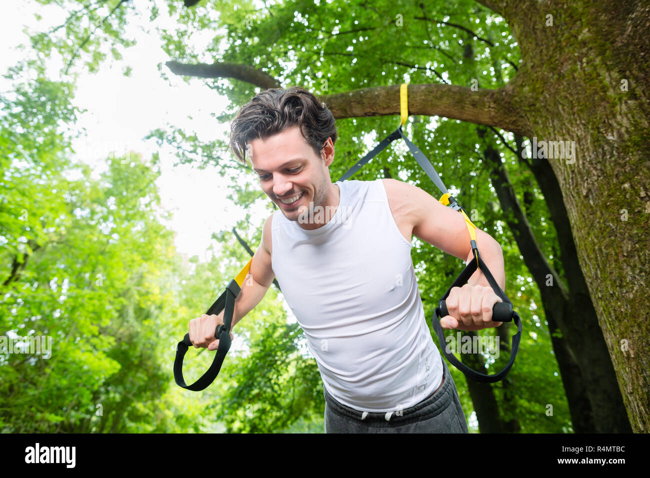 man doing suspension trainer sling sport Stock Photo - Alamy
