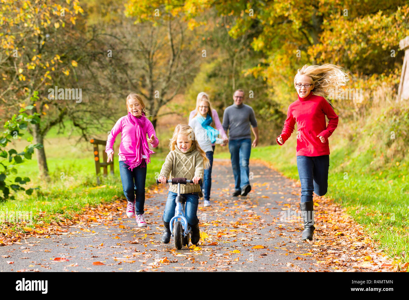 Family taking walk in autumn fall forest Stock Photo - Alamy
