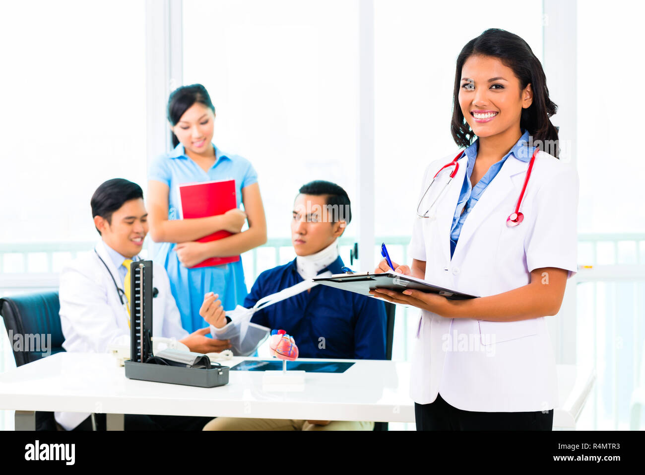 Asian doctor check-up on patient Stock Photo - Alamy