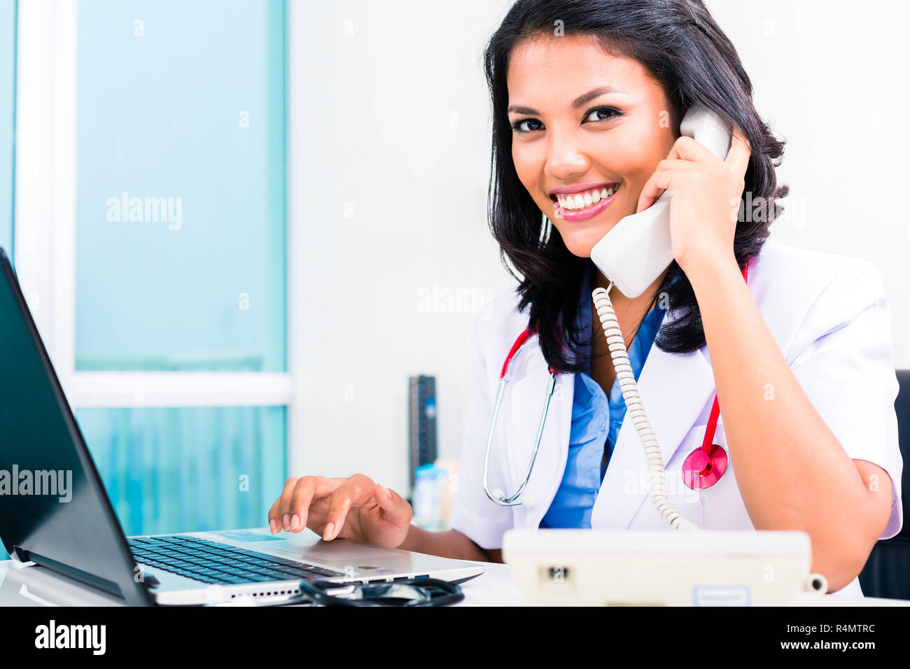 Asian doctor in office administration work Stock Photo - Alamy