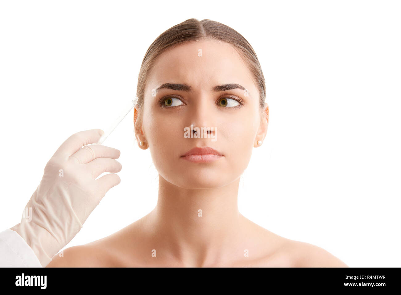 Portrait of an attractive young woman receiving botox treatment ...