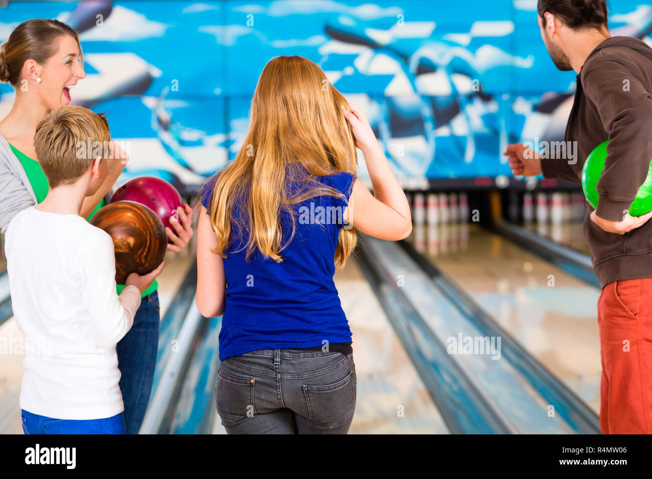 Family at Bowling Center Stock Photo - Alamy