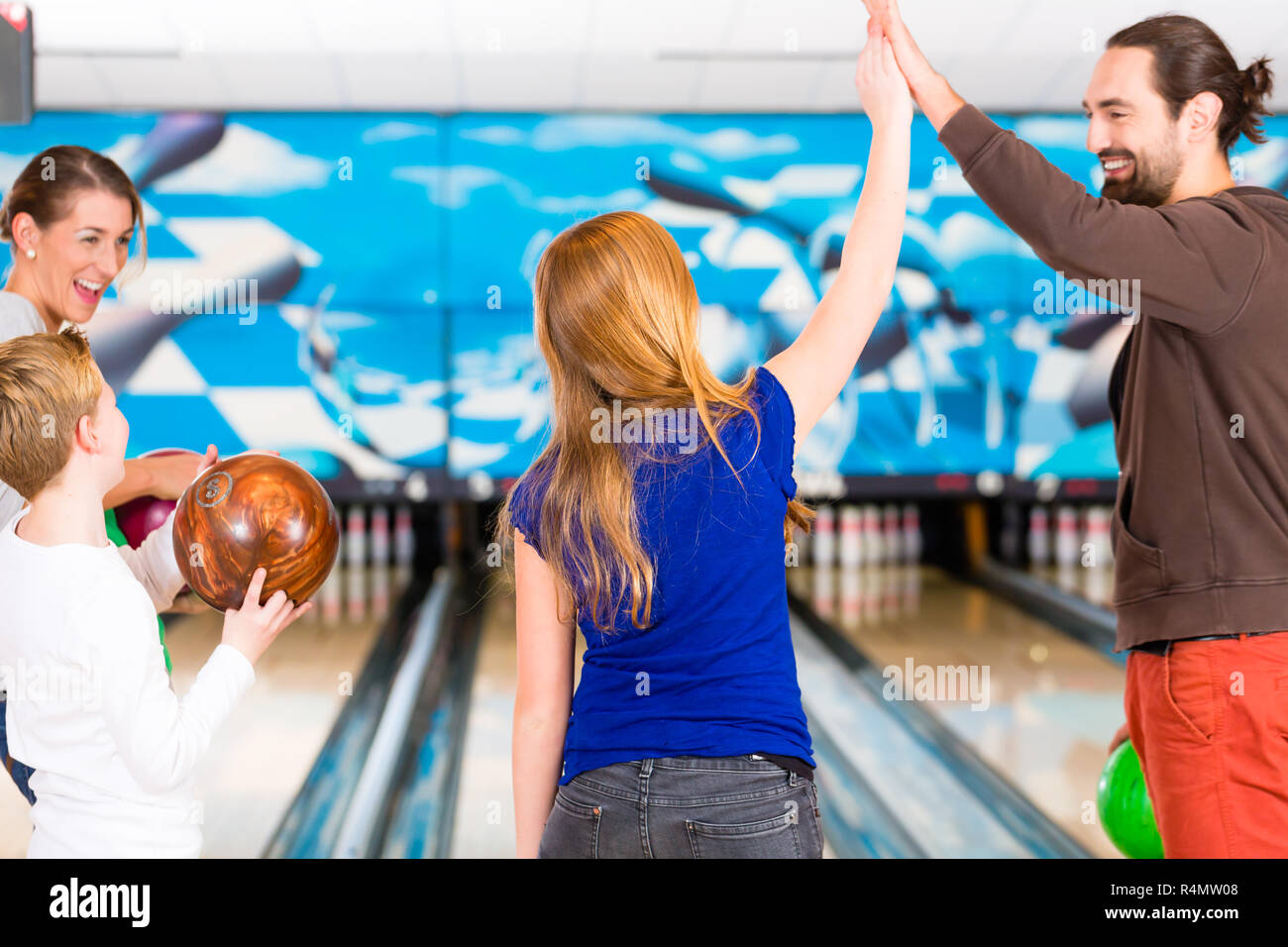 Family at Bowling Center Stock Photo - Alamy