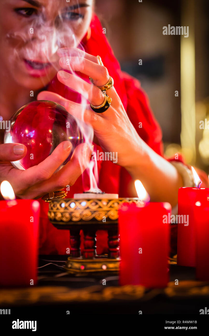 Soothsayer in Seance with Crystal ball and smoke Stock Photo - Alamy