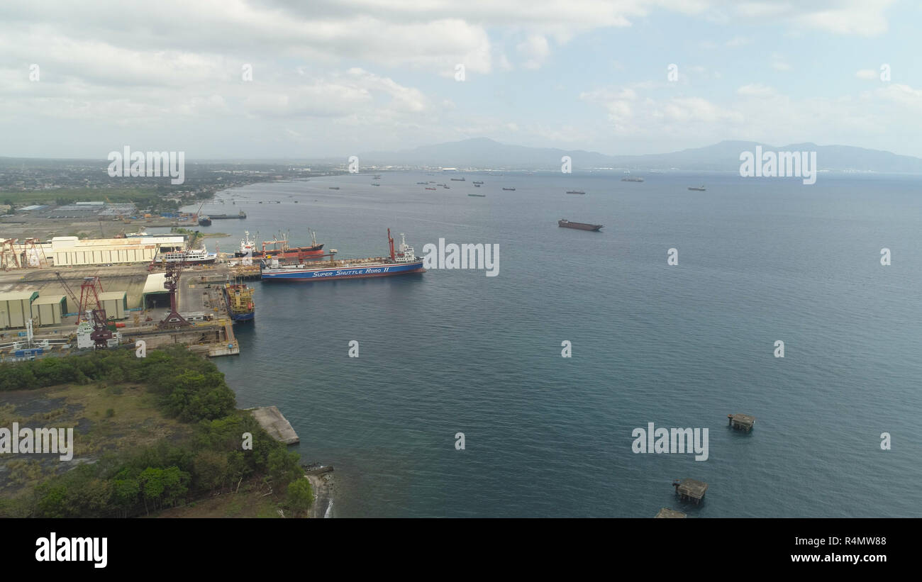 Aerial view of shipyard with ships in docks, cranes and warehouses ...