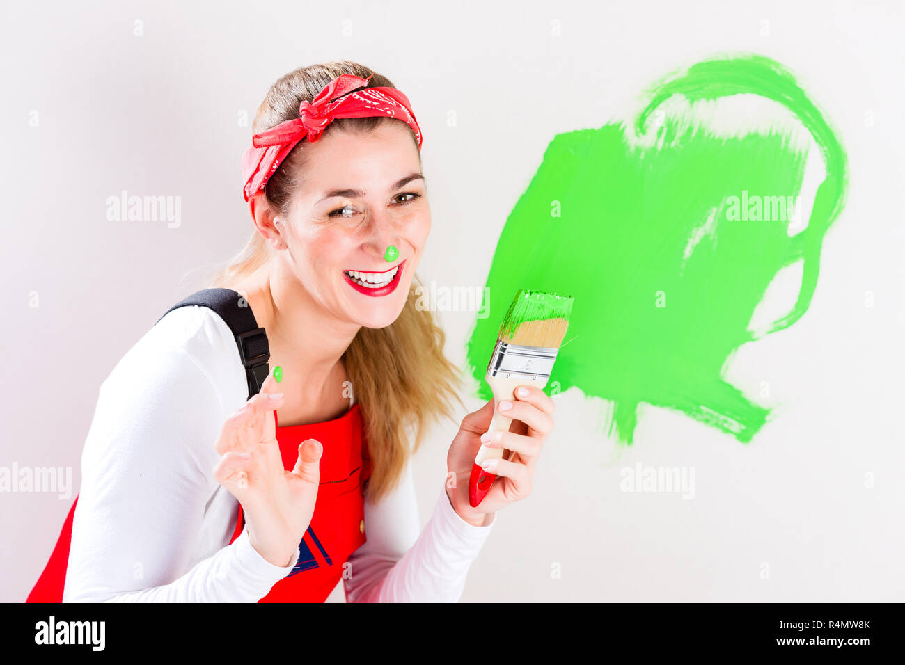Woman having fun painting wall Stock Photo - Alamy