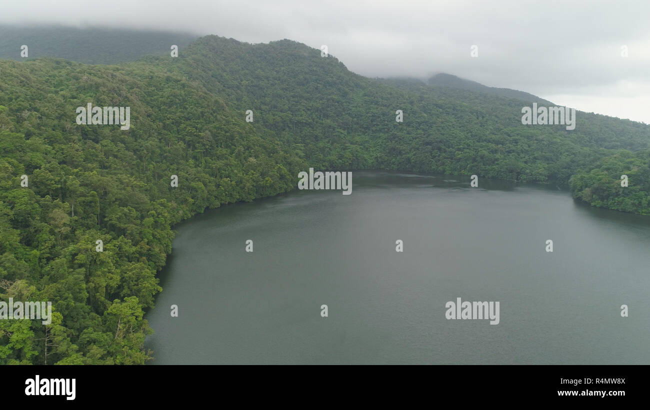 Aerial view of lake Bulusan in the mountains with green rain forest ...