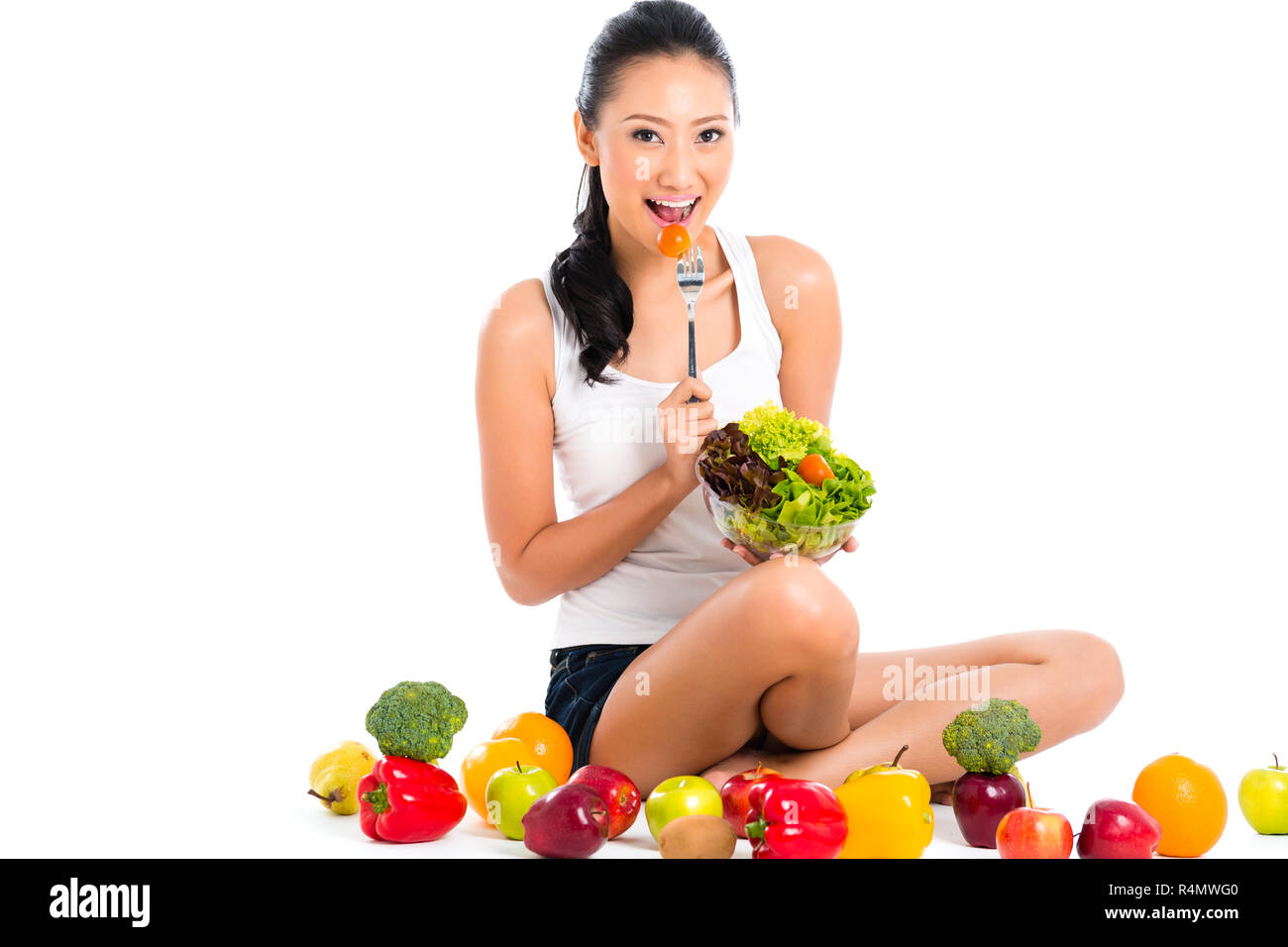 Asian Chinese woman eating healthy salad Stock Photo - Alamy
