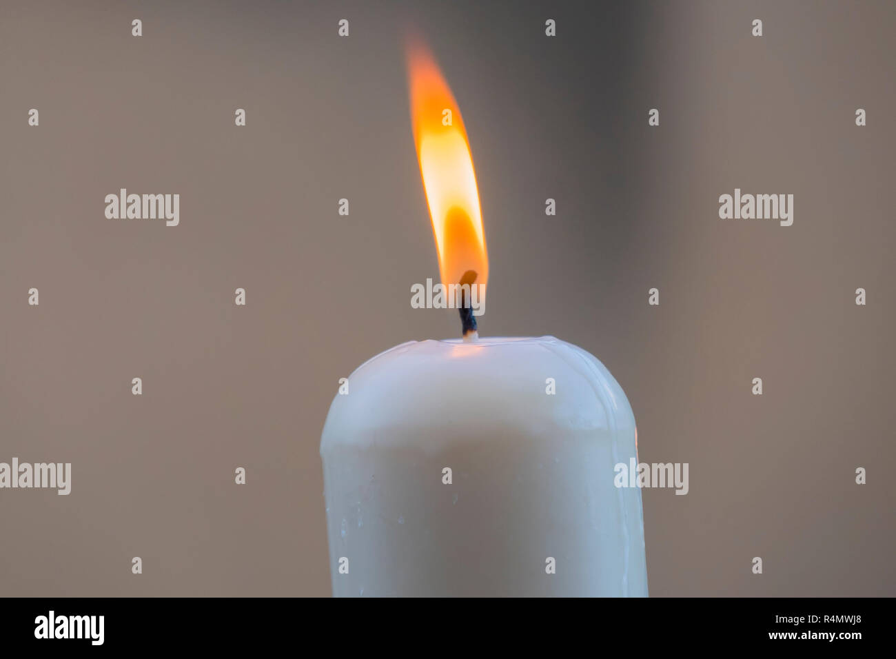 White candle with the flame Stock Photo - Alamy