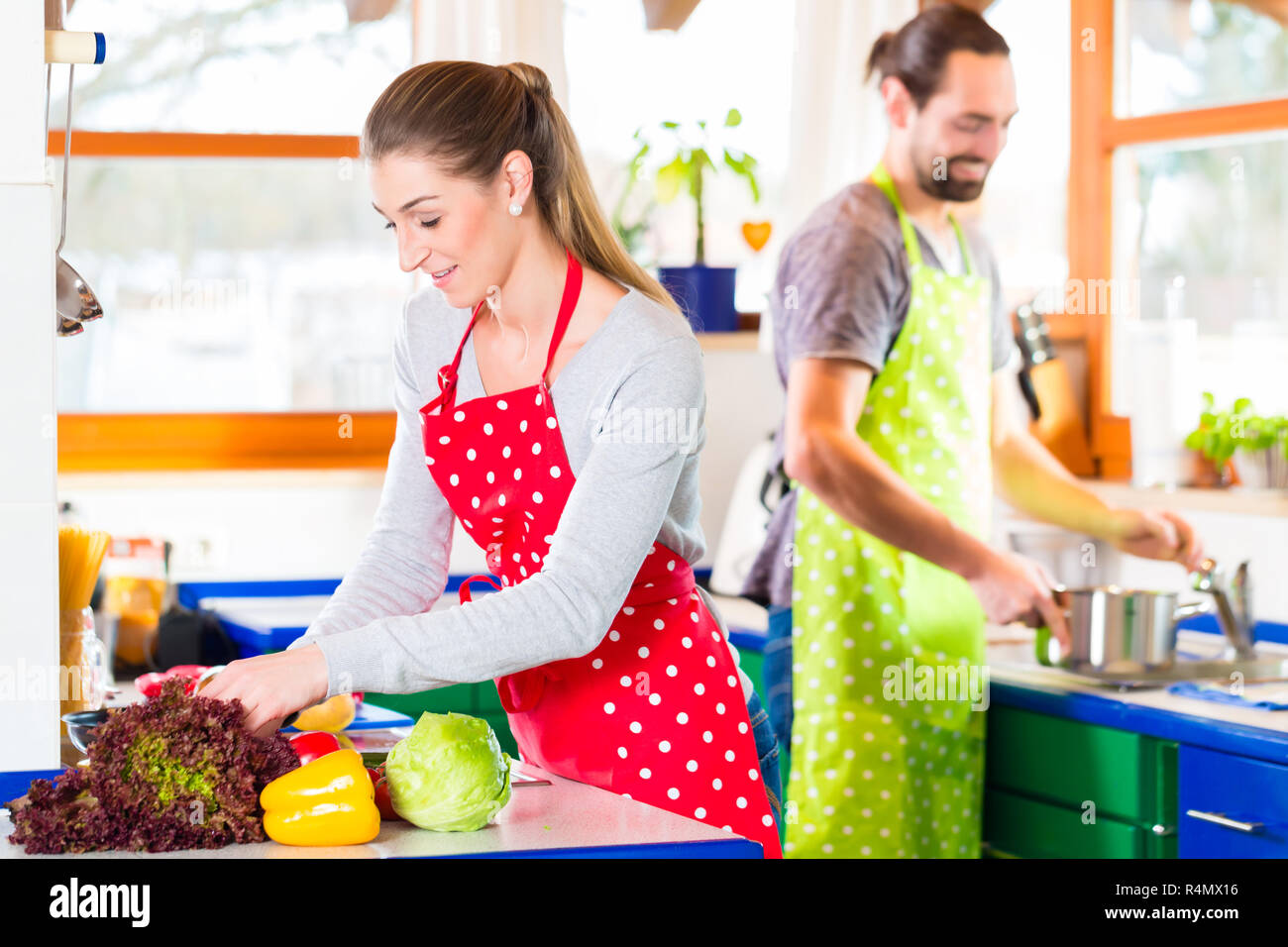 Couple cooking in domestic kitchen healthy food Stock Photo - Alamy