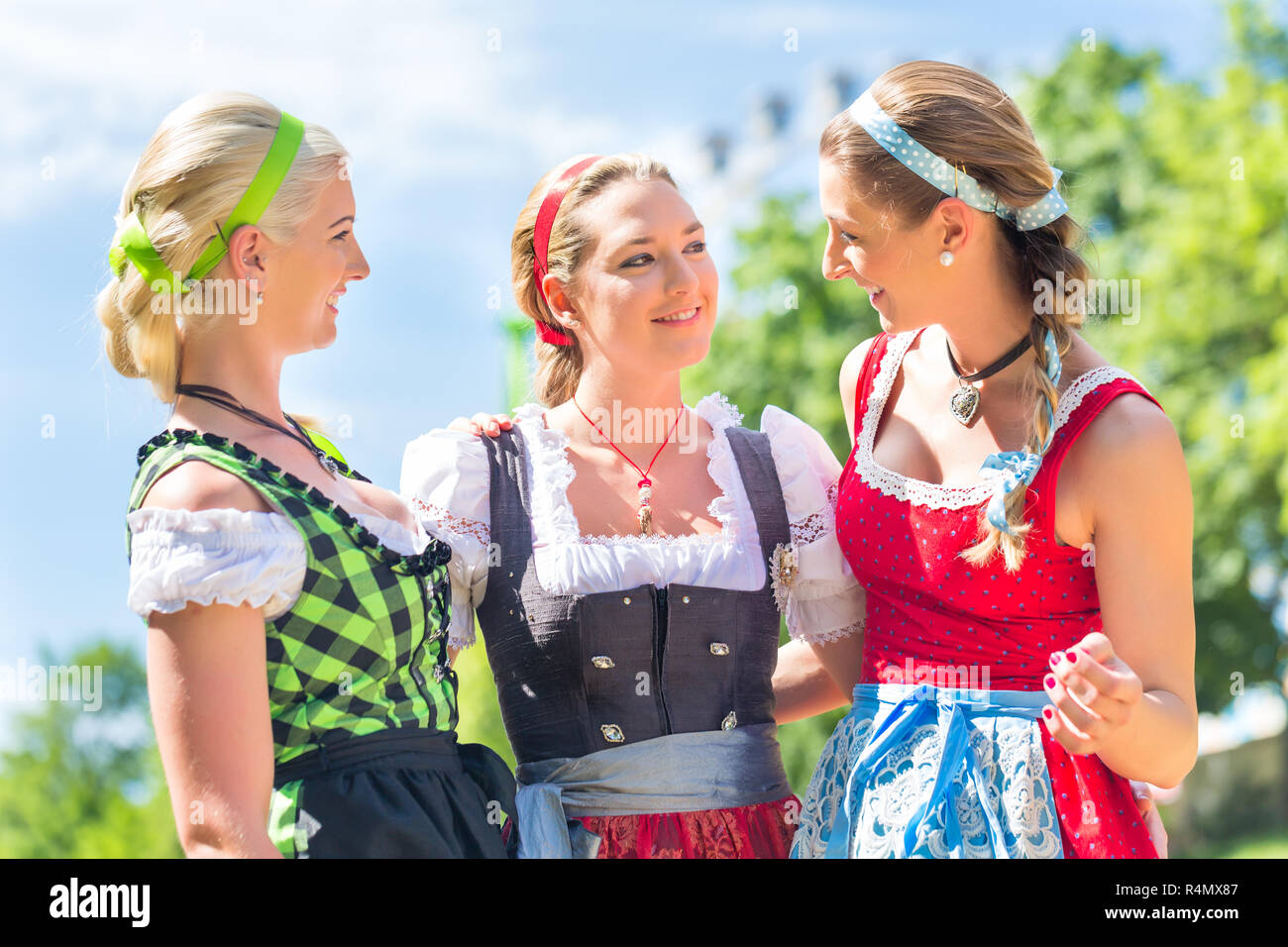 Friends visiting Bavarian fair having fun Stock Photo - Alamy