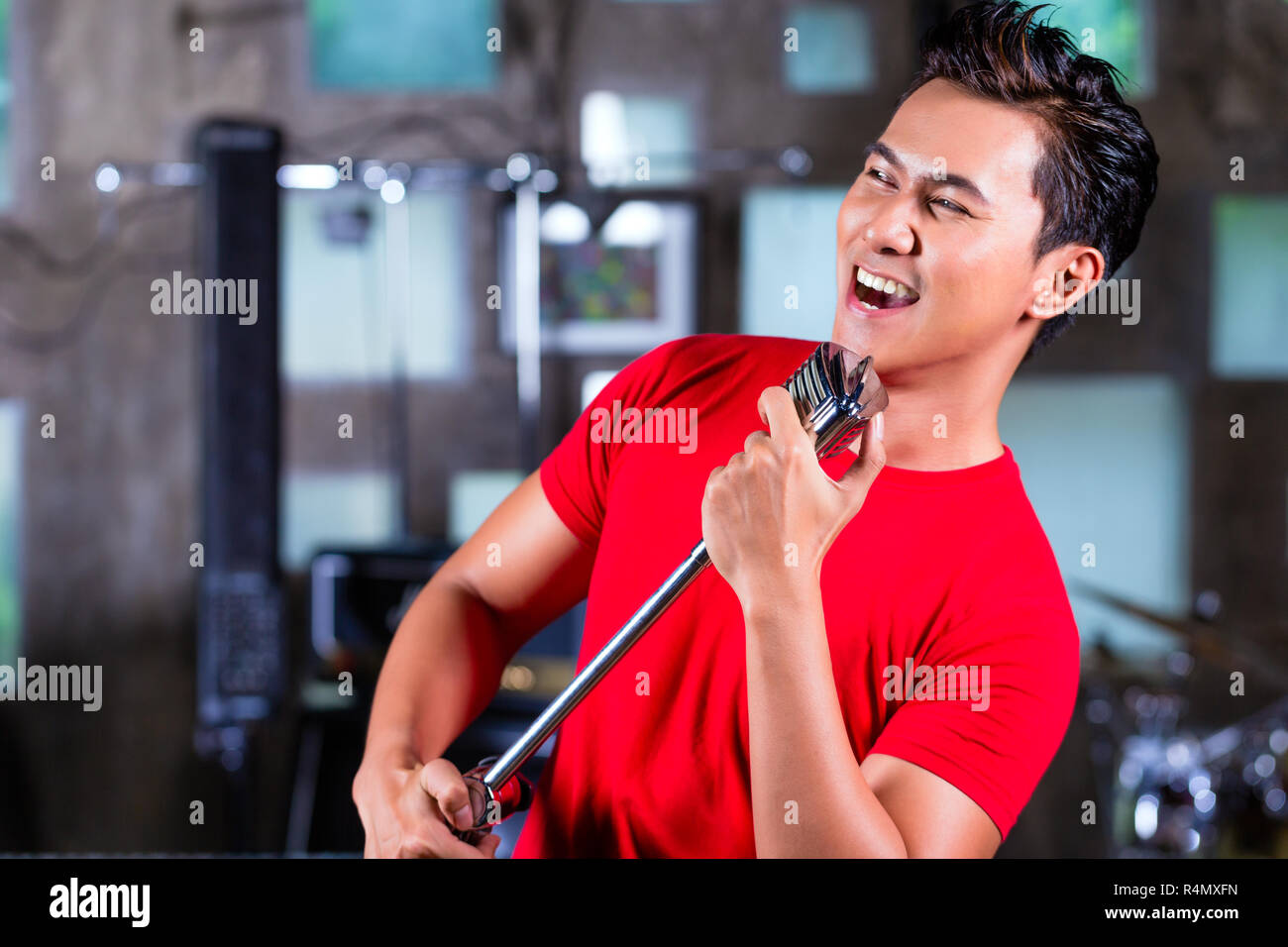 Asian singer producing song in recording studio Stock Photo - Alamy