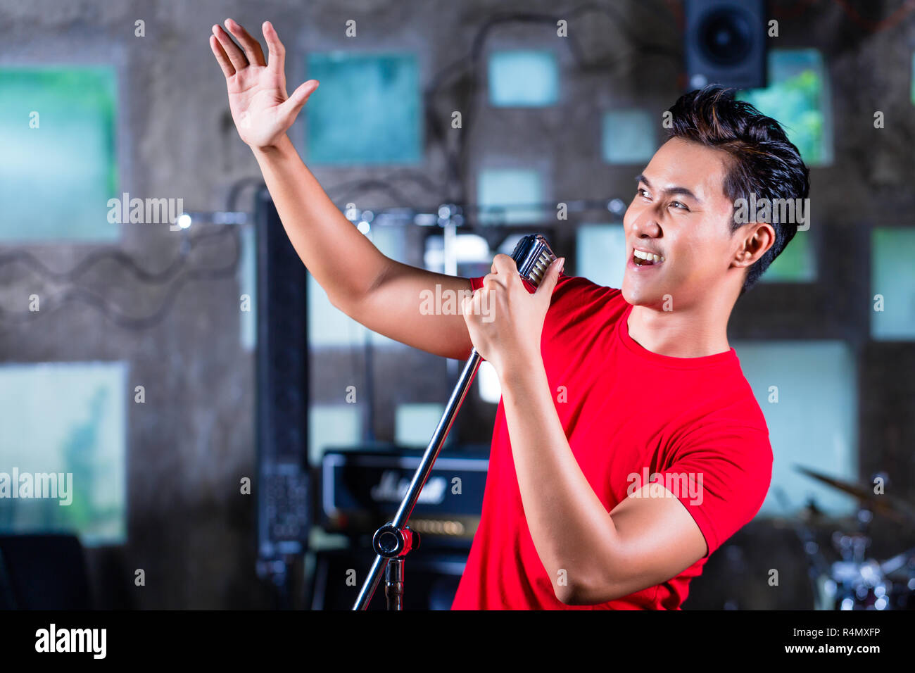Asian singer producing song in recording studio Stock Photo - Alamy