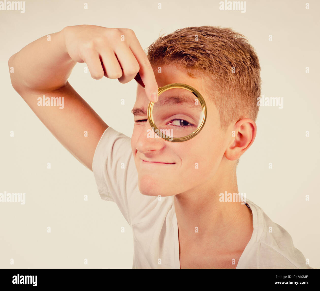 funny teenage boy with magnifier Stock Photo - Alamy