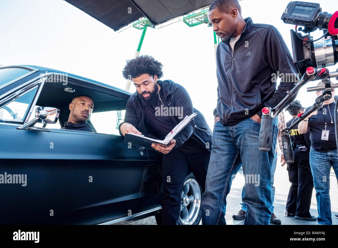 CREED II, (from left): Michael B. Jordan (in car), director Steve Caple ...