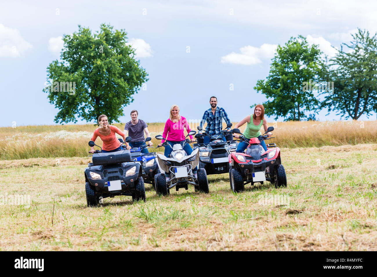 Friends driving off-road with quad bike or ATV Stock Photo - Alamy