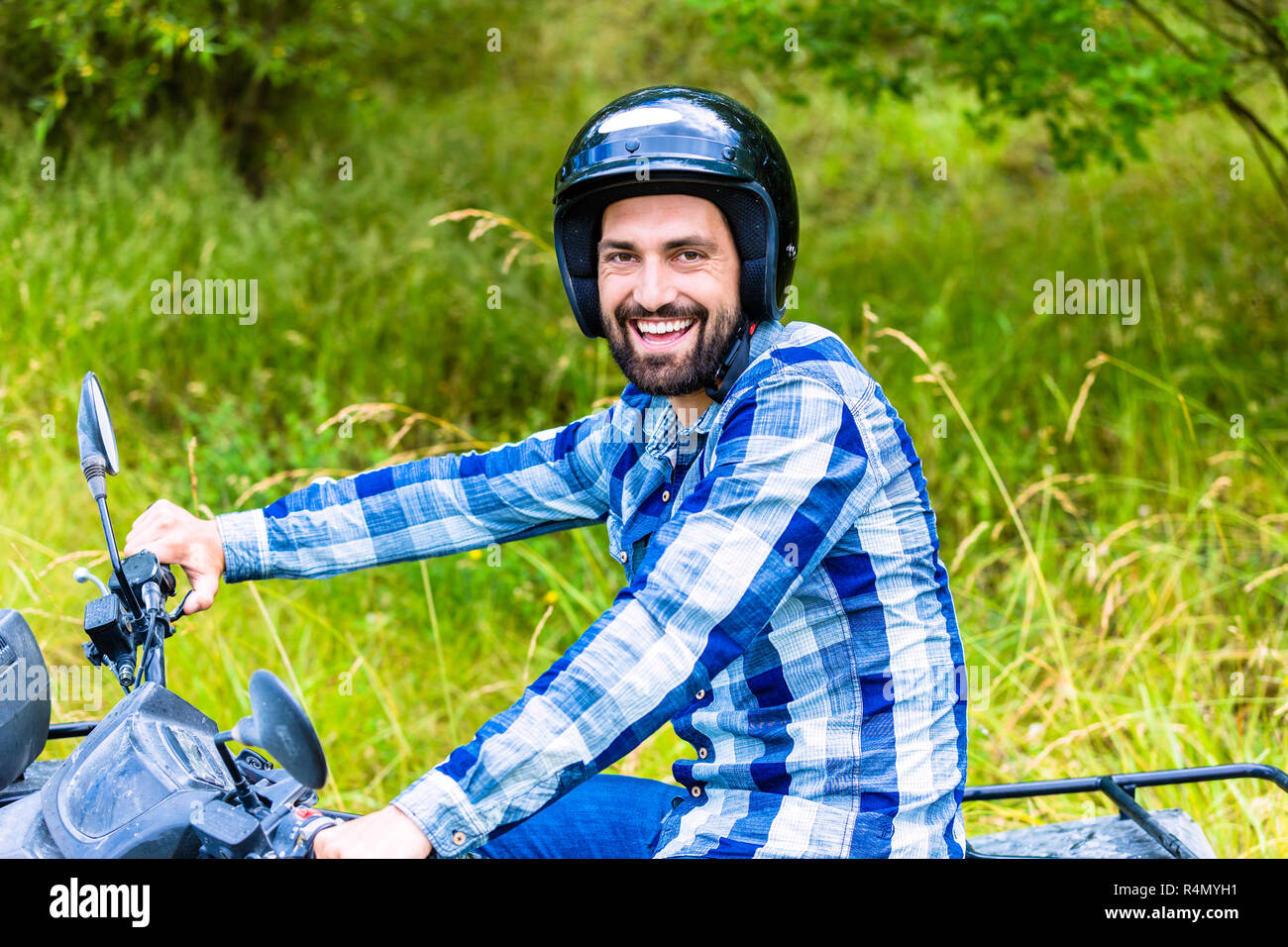 Man driving off-road with quad bike or ATV Stock Photo - Alamy