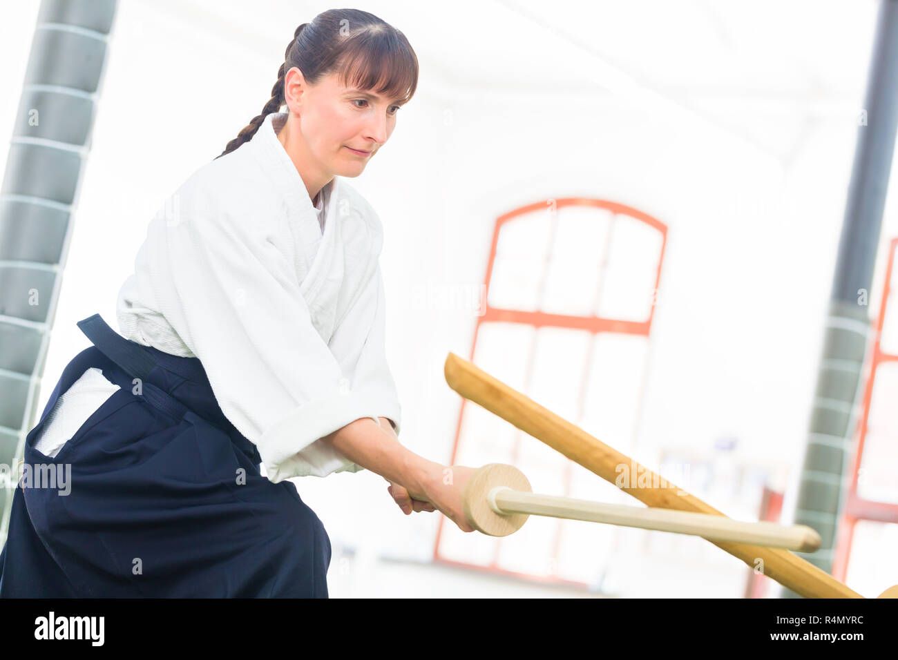 Woman having Aikido sword fight Stock Photo - Alamy