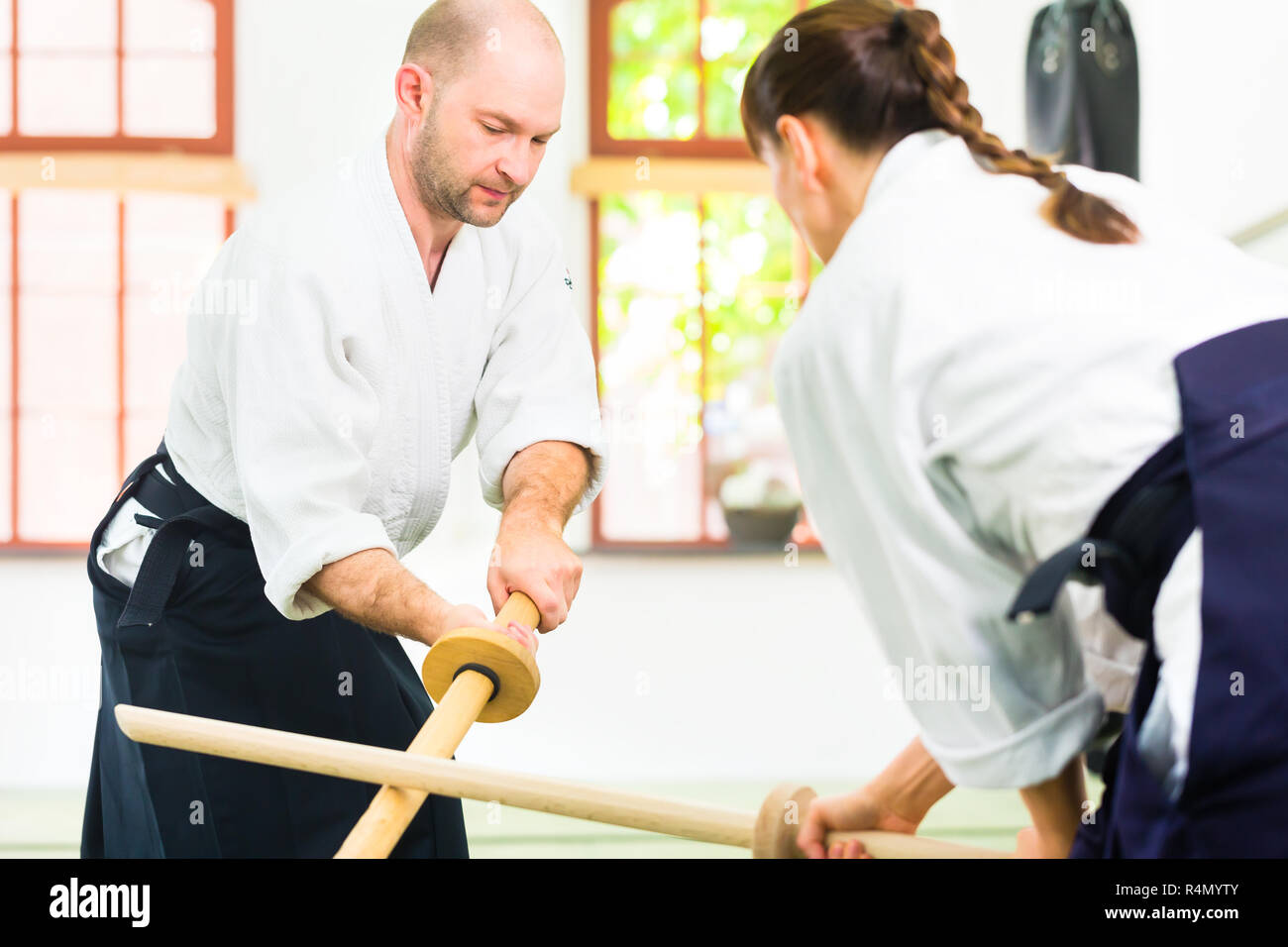 Man and woman having Aikido sword fight Stock Photo - Alamy
