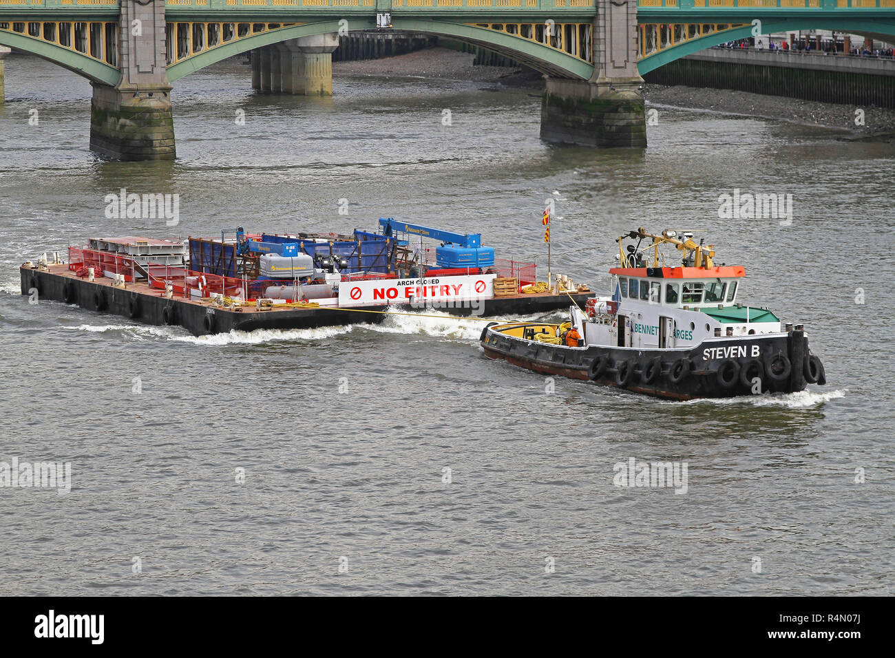 LONDON, UNITED KINGDOM - APRIL 09: Tugboat and Barge at Thames in ...