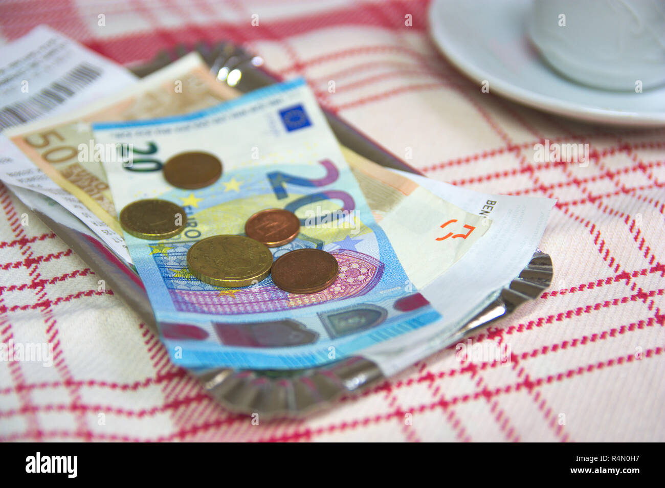 Payment of a cash account with a cup of coffee at a restaurant table ...