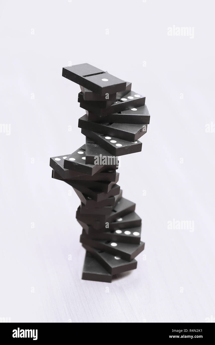 close up. tower built of Domino chips on white background Stock Photo ...