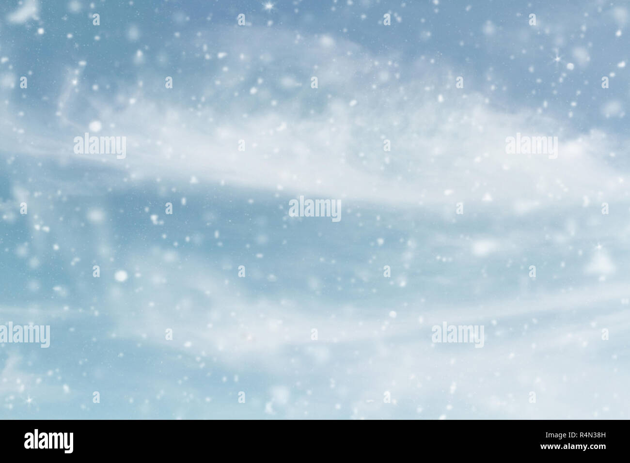 Snowy wintry sky. Blurred background of snow falling against cool blue ...