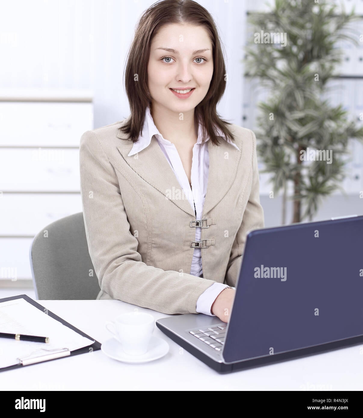 Executive business woman sitting at her Desk Stock Photo - Alamy