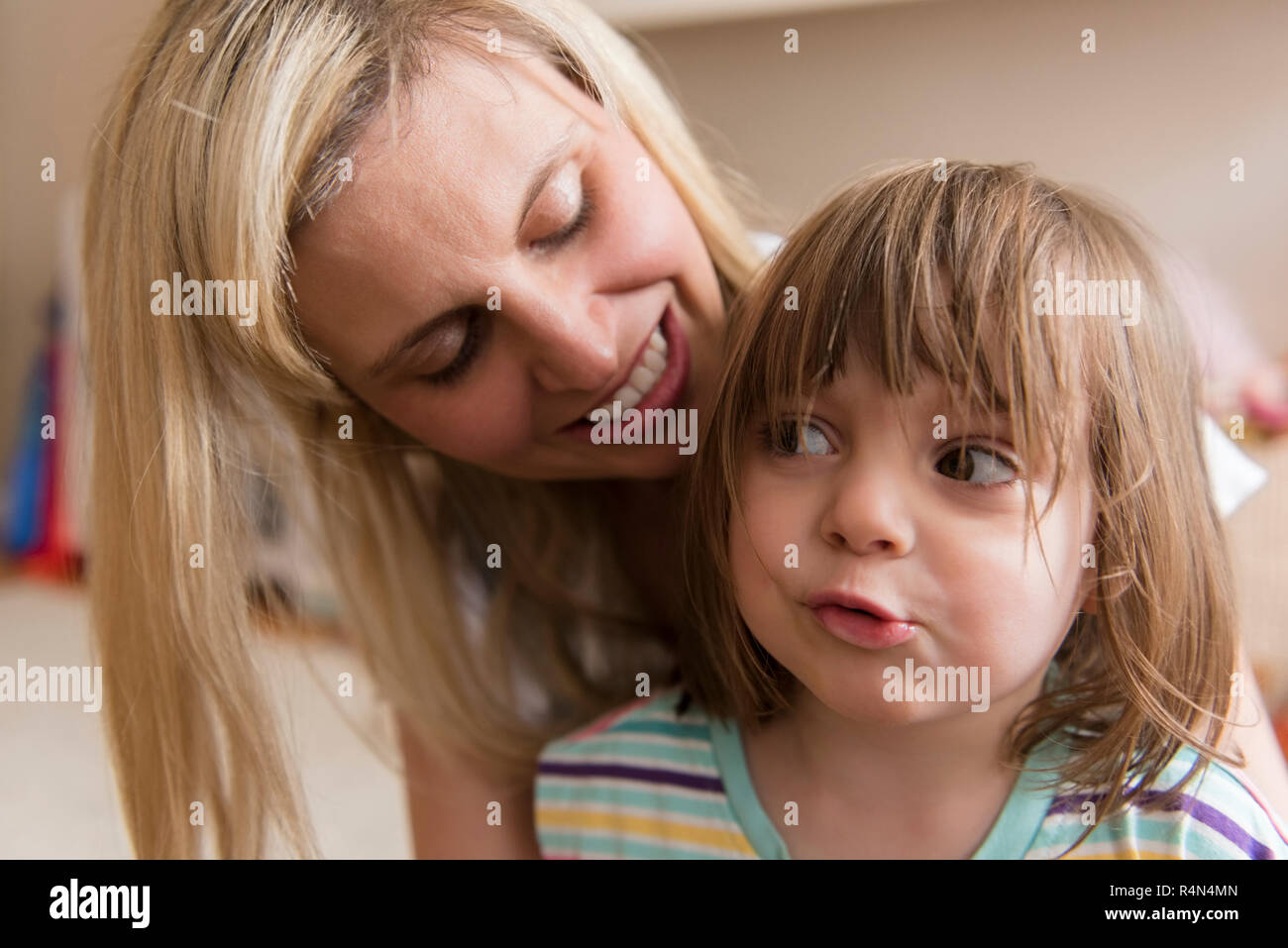 Smiling mother bonding with her daughter Stock Photo - Alamy
