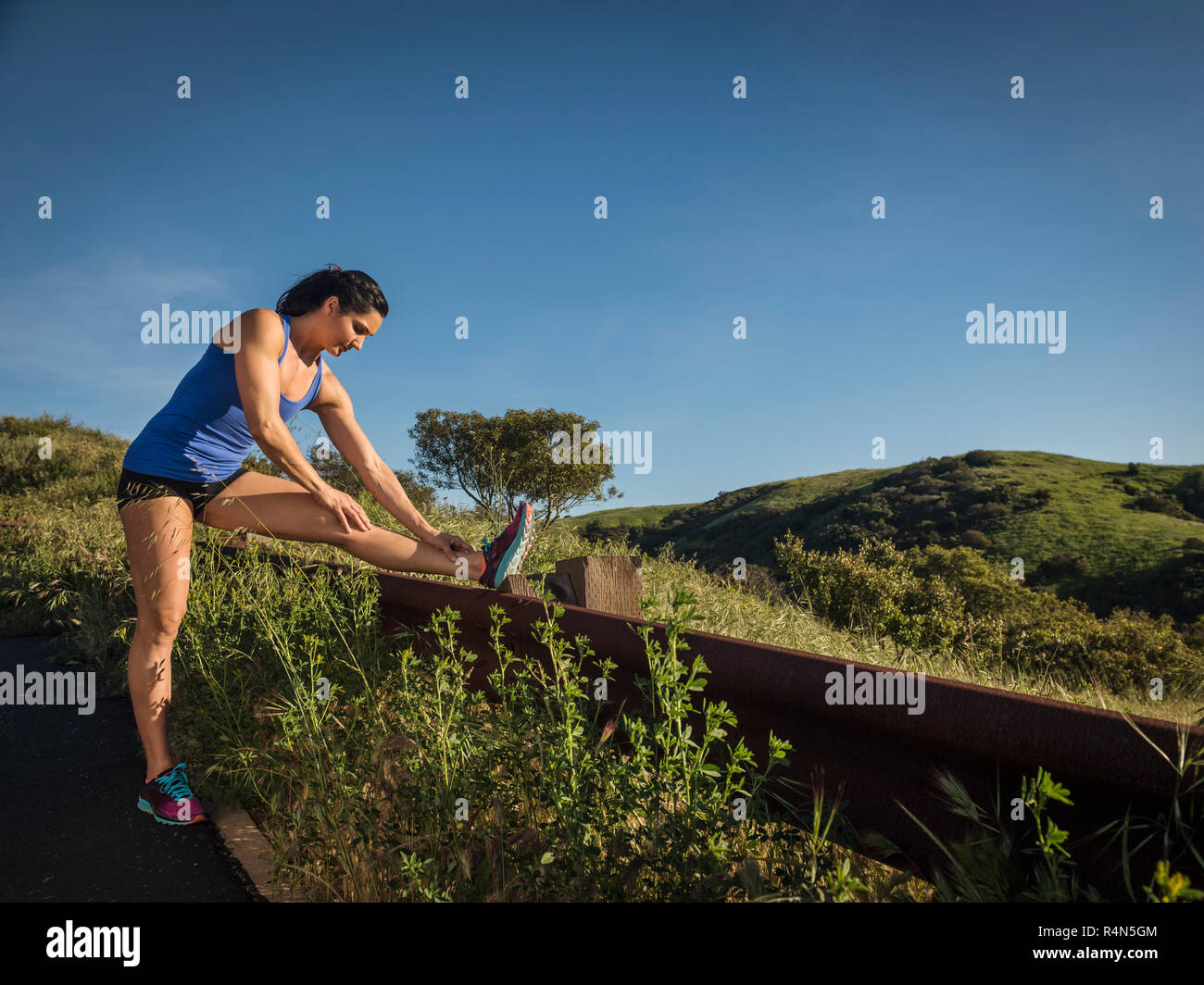 Fence stretching leg women hi-res stock photography and images - Alamy
