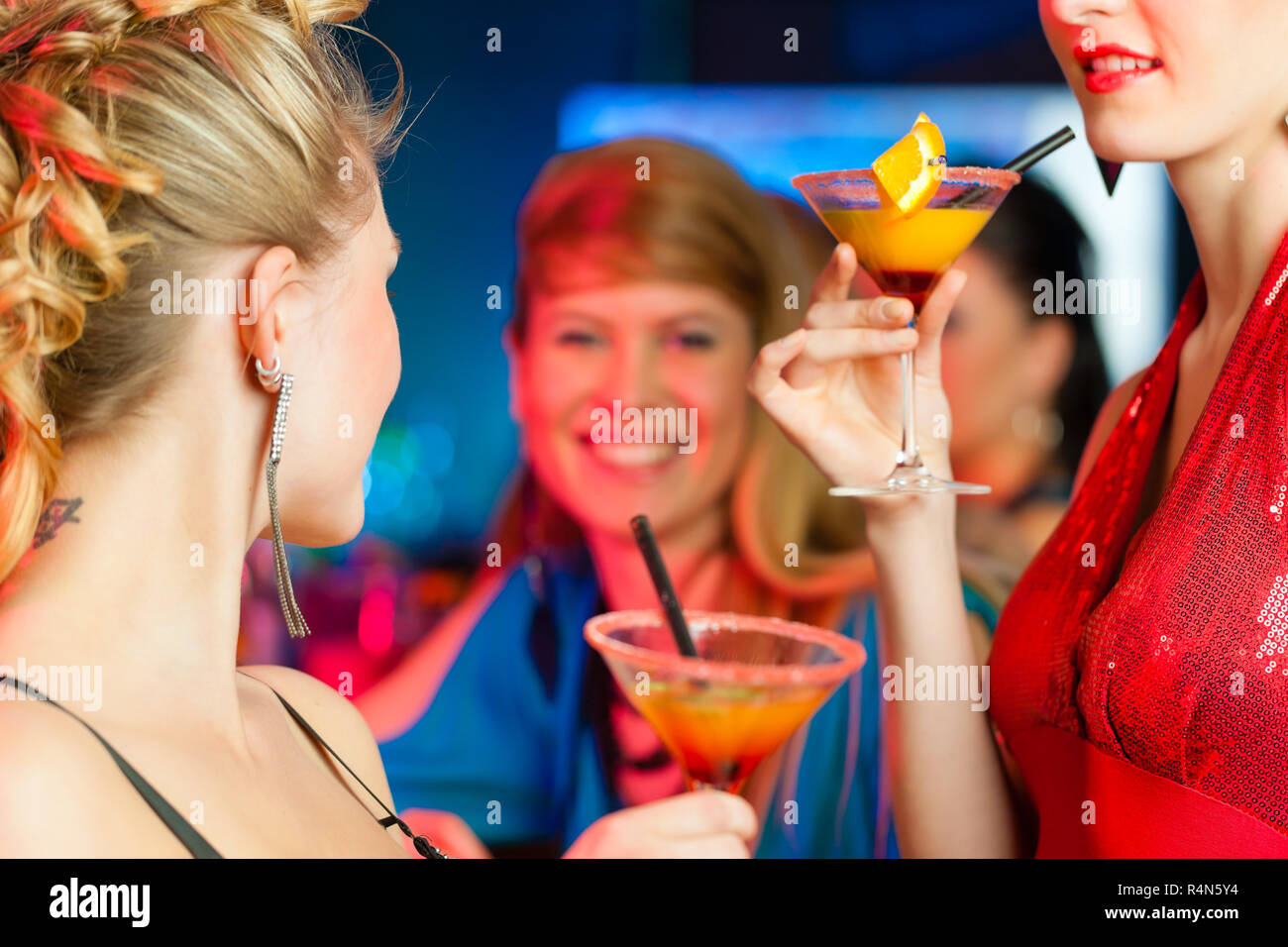 People in club or bar drinking cocktails Stock Photo - Alamy