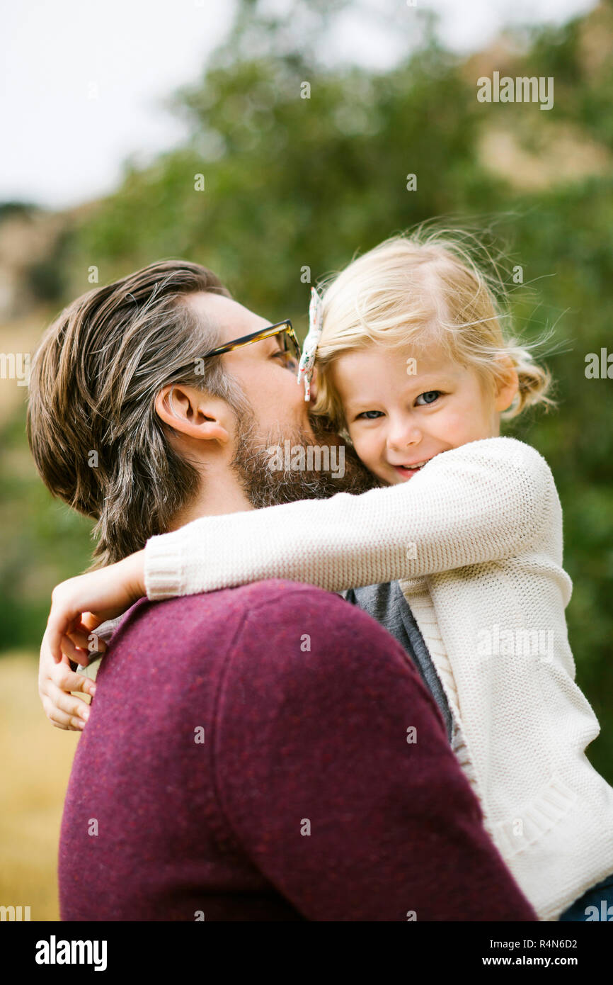 Man hugging his daughter Stock Photo - Alamy