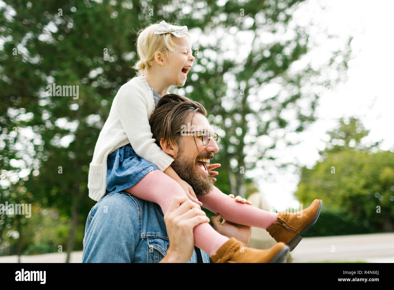 Father giving daughter piggyback ride Stock Photo - Alamy