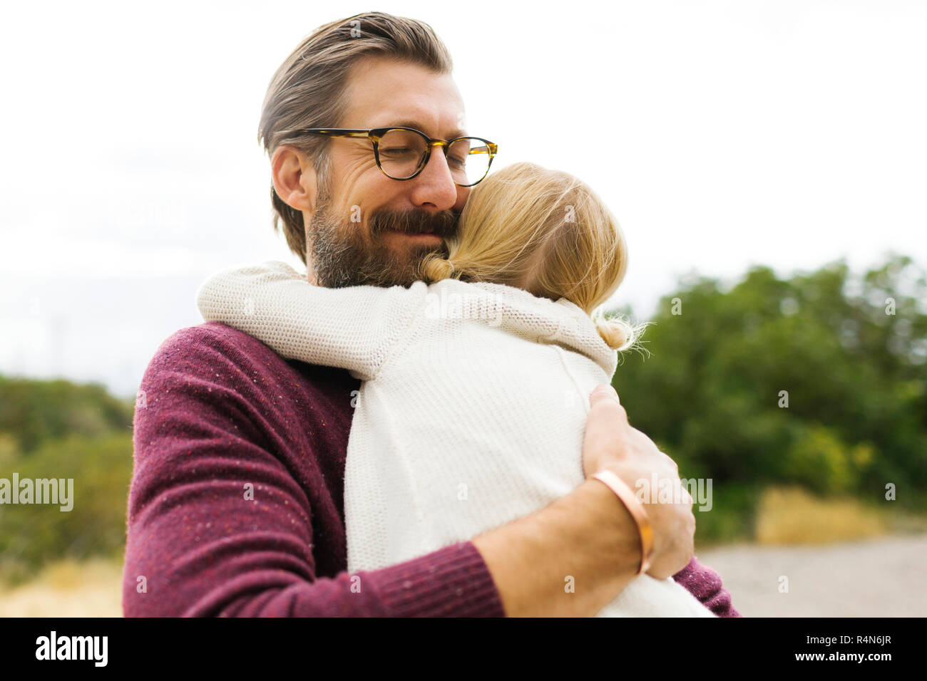 Man hugging his daughter Stock Photo - Alamy