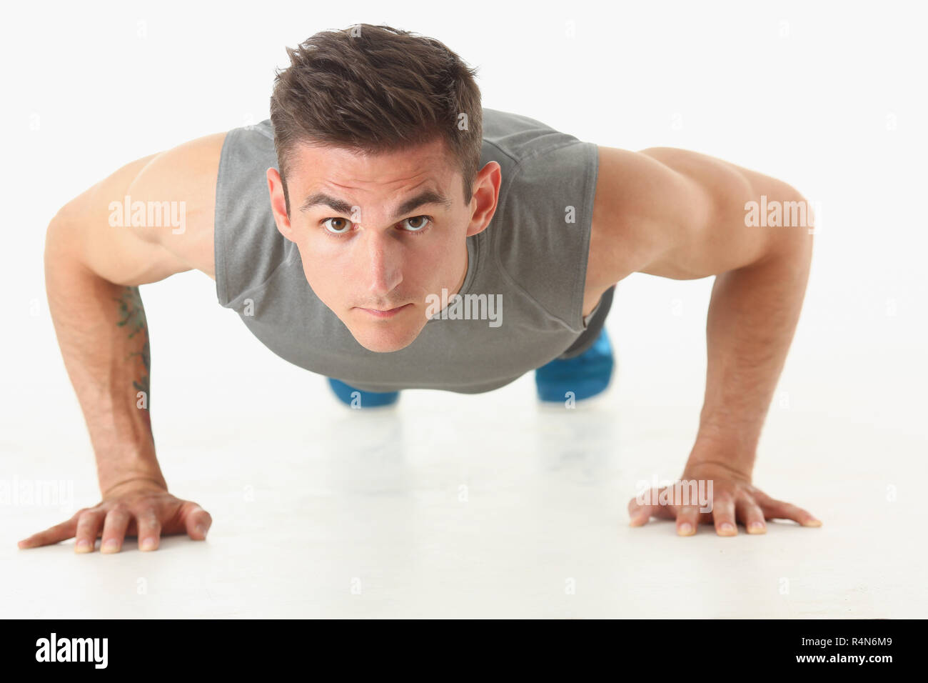 Fitness man wringing from the floor demonstrates Stock Photo - Alamy
