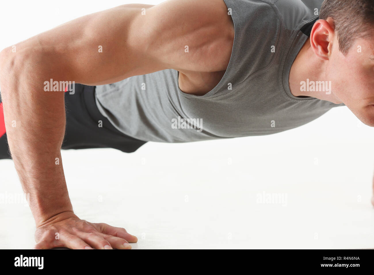 Fitness man wringing from the floor demonstrates Stock Photo - Alamy
