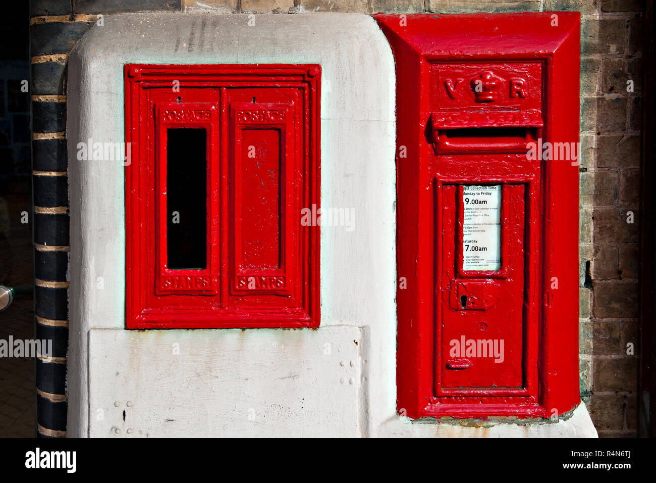 A wall mounted Victorian post box alongside an unused Type E stamp ...
