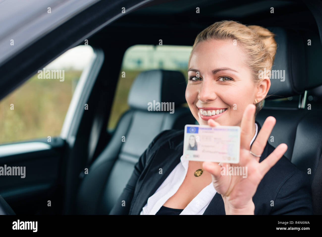 Woman showing her driving license out of car Stock Photo - Alamy