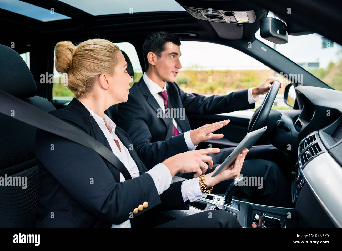 Couple in car being lost navigating with map Stock Photo - Alamy