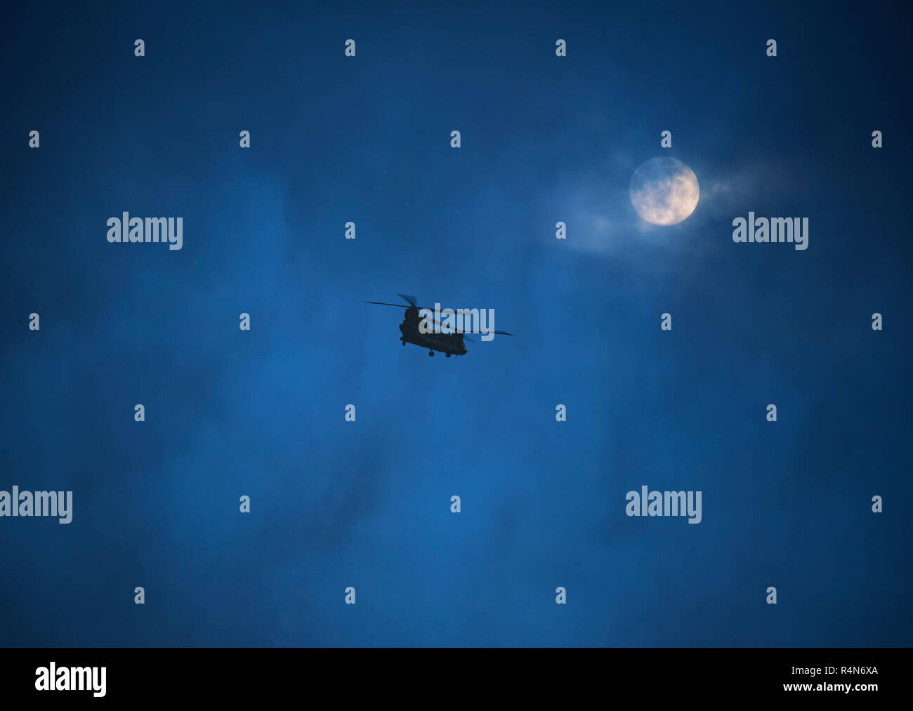 Military helicopter in night sky Stock Photo - Alamy