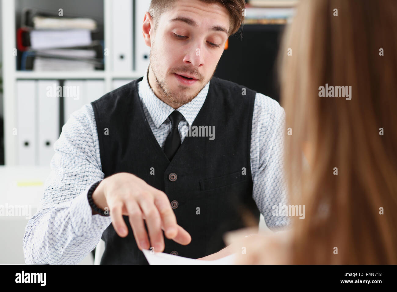 Handsome man in suit offer contract form Stock Photo - Alamy
