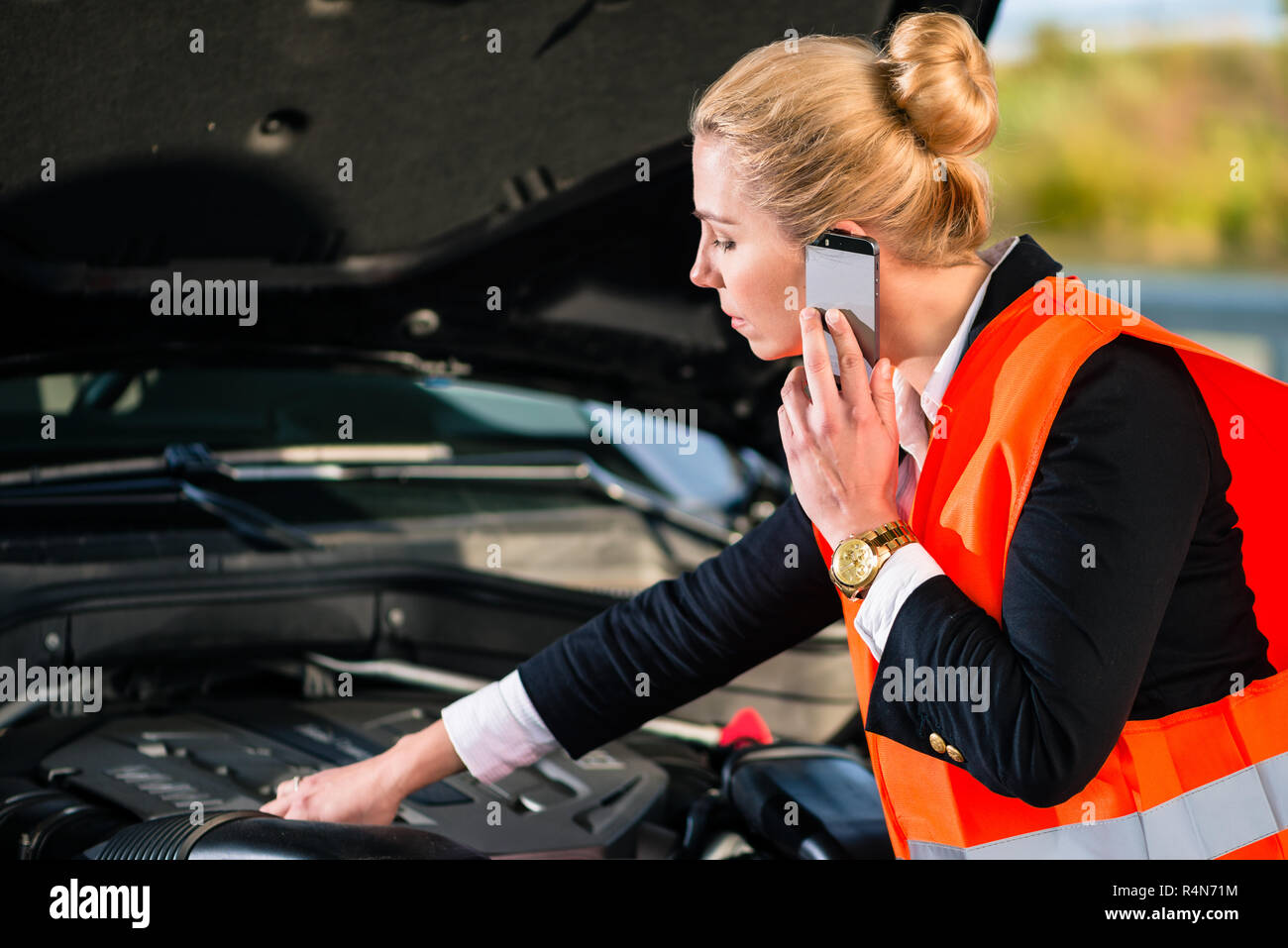 Woman with car engine problems calling repair service Stock Photo - Alamy