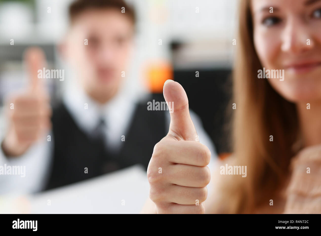 Beautiful smiling woman showing OK Stock Photo - Alamy