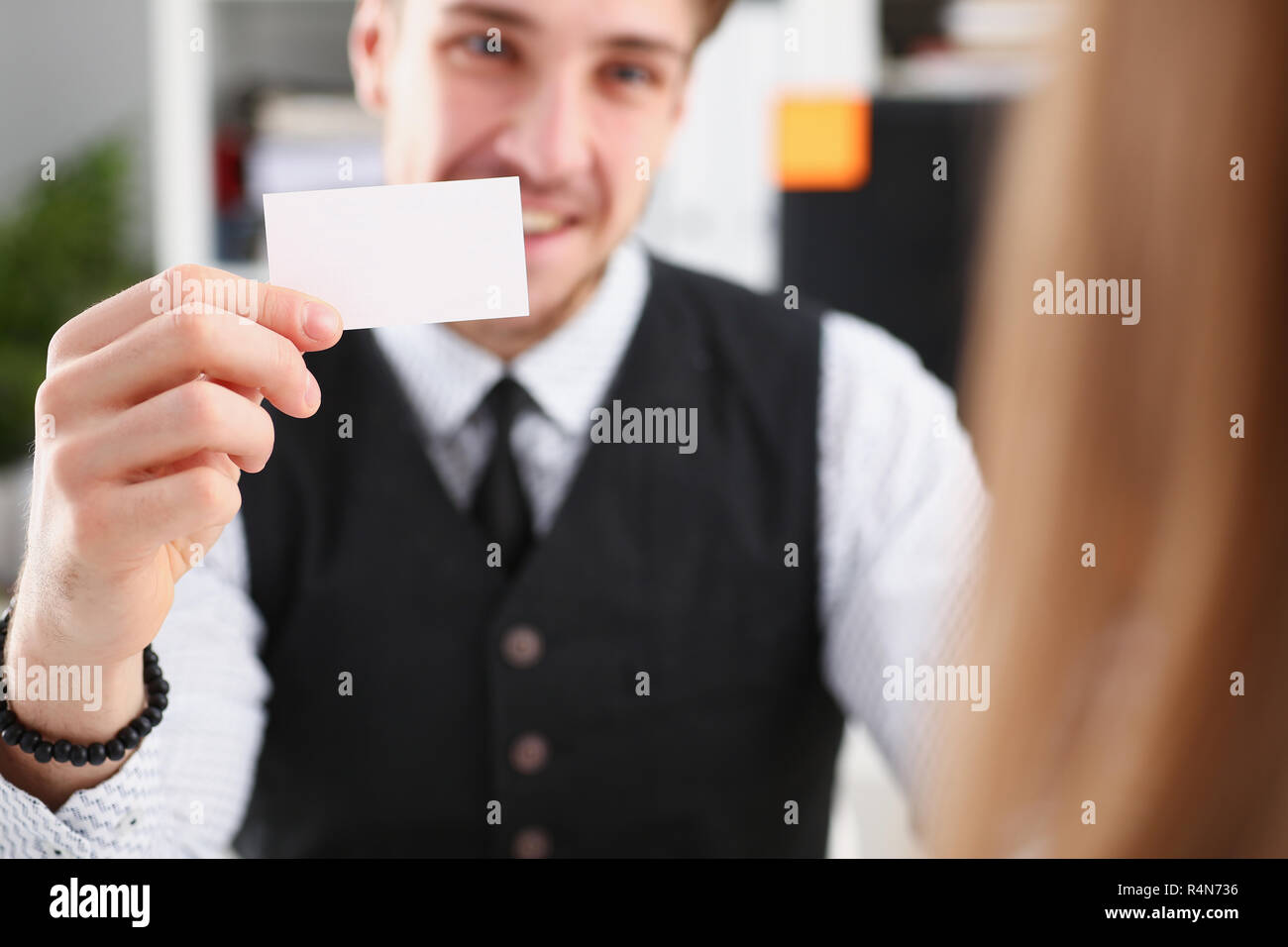 Male hand in suit give blank calling card to visitor Stock Photo - Alamy