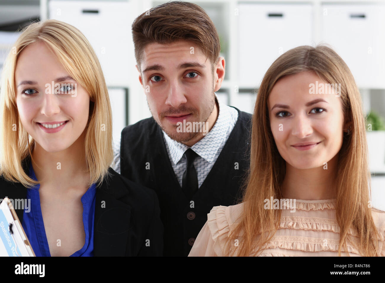Group of smiling people stand in office looking in camera Stock Photo ...