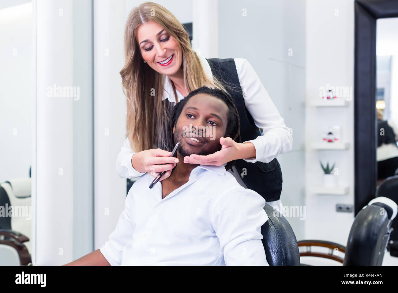 Woman barber shaving man in hi-res stock photography and images - Alamy