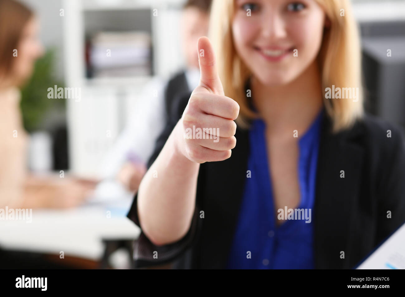 Beautiful smiling woman showing OK Stock Photo - Alamy