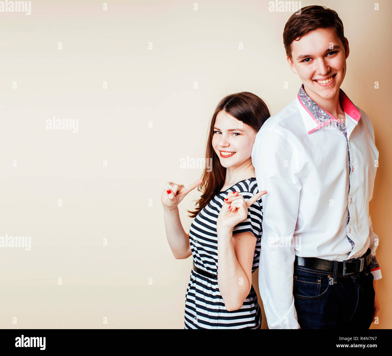 couple of happy smiling teenagers students, warm colors having a Stock ...